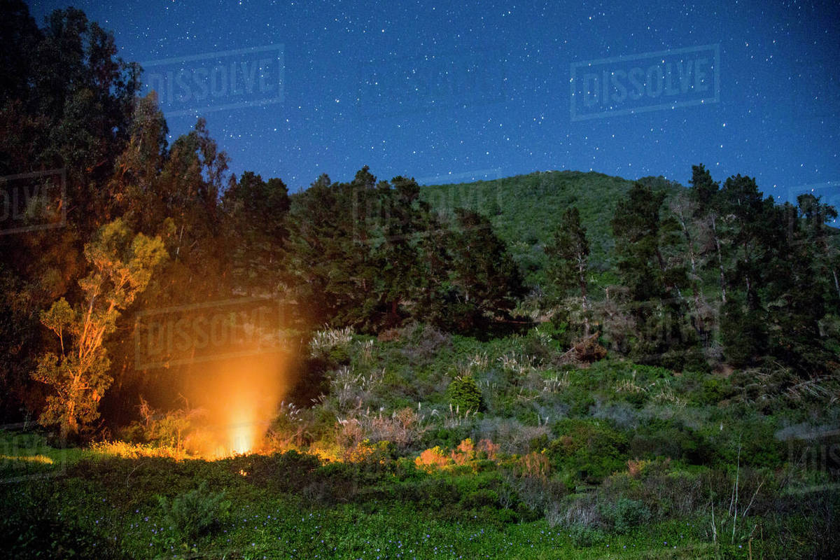 Campfire at night under starry sky - Royalty-free Stock Photo | Dissolve