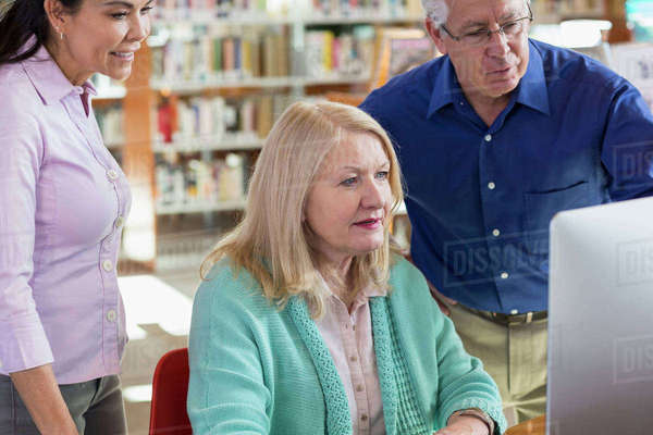 Older people using computer in library - Royalty-free Stock Photo ...