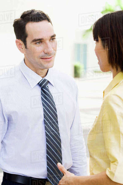 Business people talking outdoors - Stock Photo - Dissolve