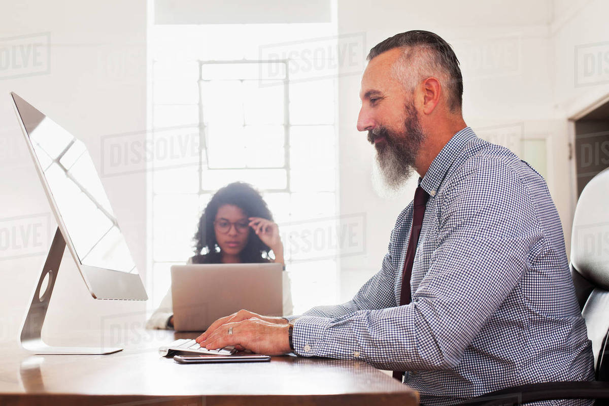 Man using computer desk - Royalty-free Stock Photo | Dissolve