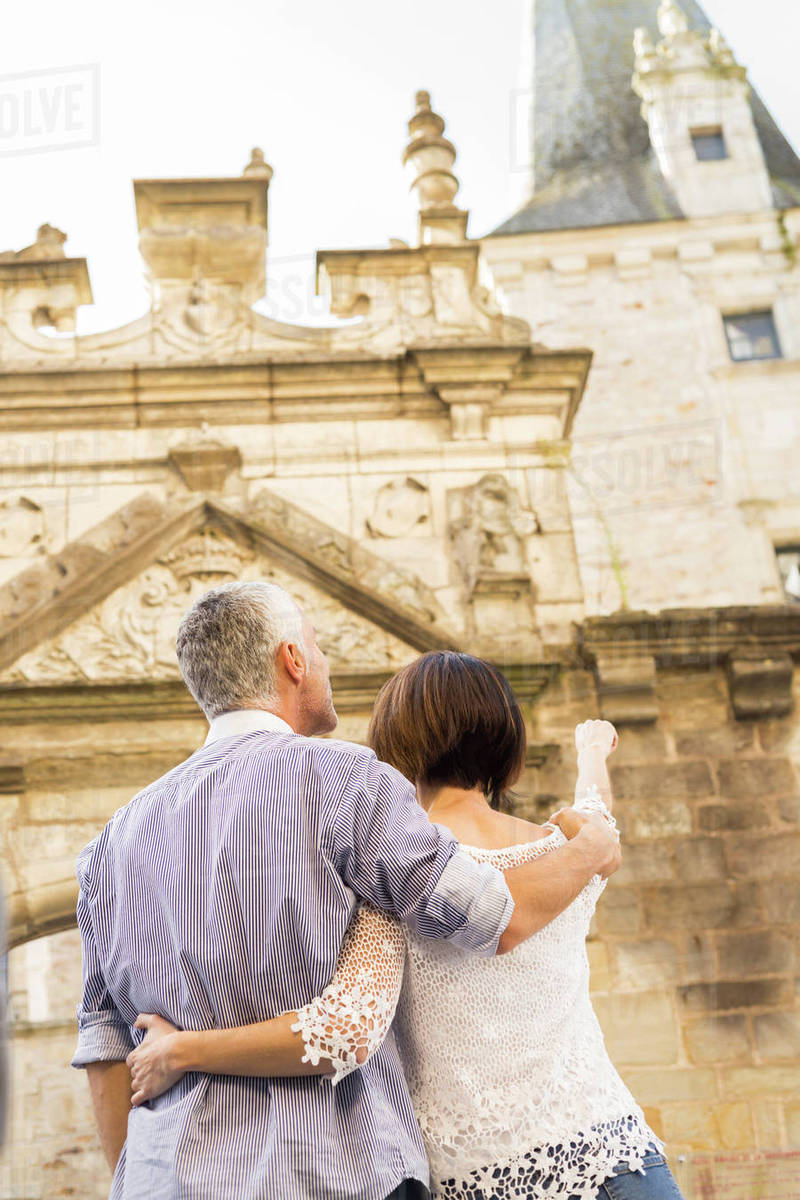 Caucasian couple admiring building - Royalty-free Stock Photo | Dissolve Caucasian couple admiring building - Royalty-free Stock Photo | Dissolve