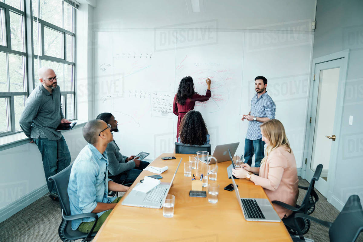 Business people using whiteboard in meeting - Royalty-free Stock Photo ...