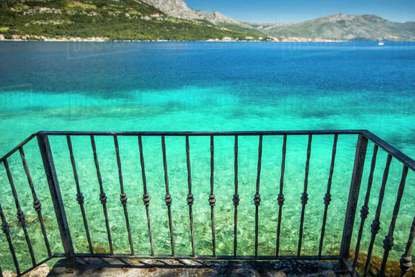 Balcony overlooking tranquil ocean - Royalty-free Stock Photo | Dissolve
