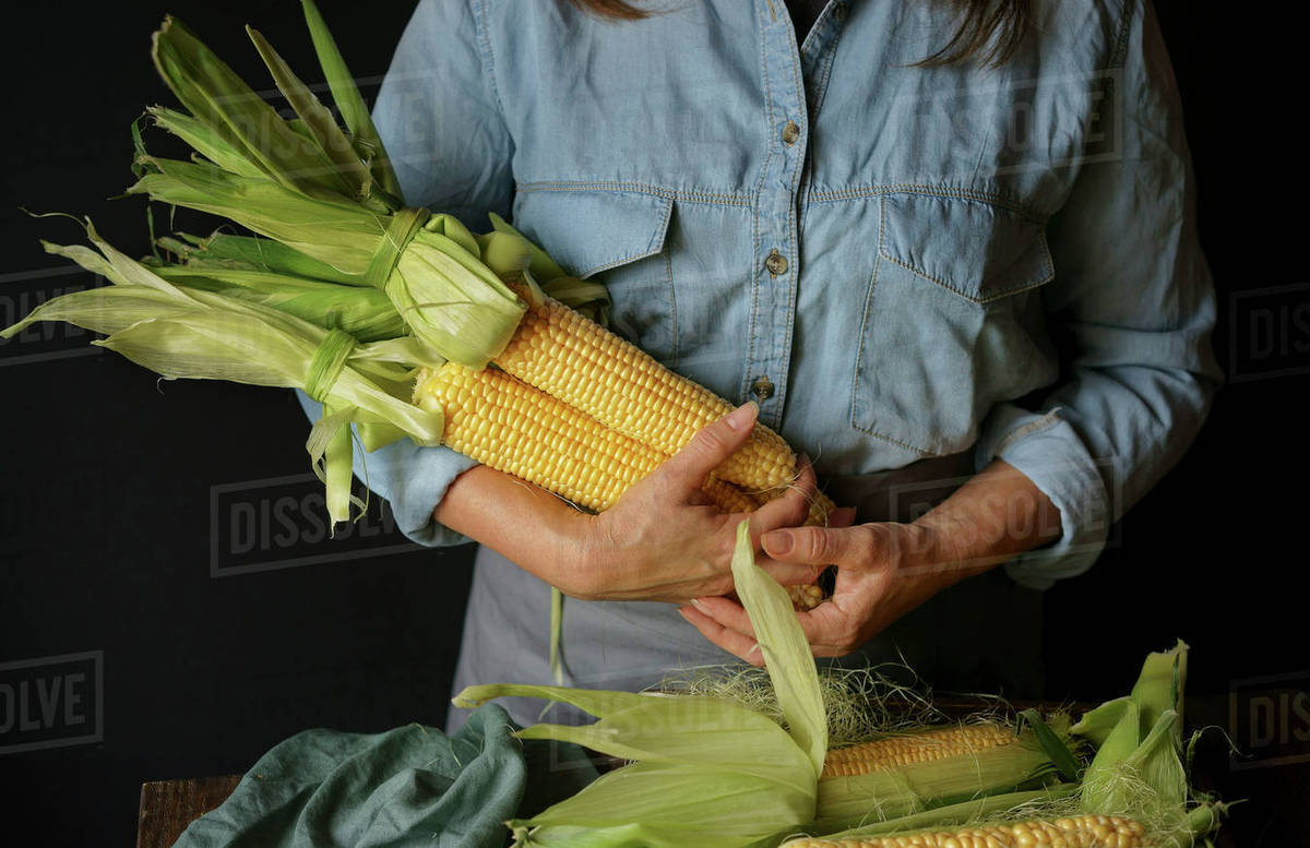 Close up of Caucasian woman holding corn - Royalty-free Stock Photo ...
