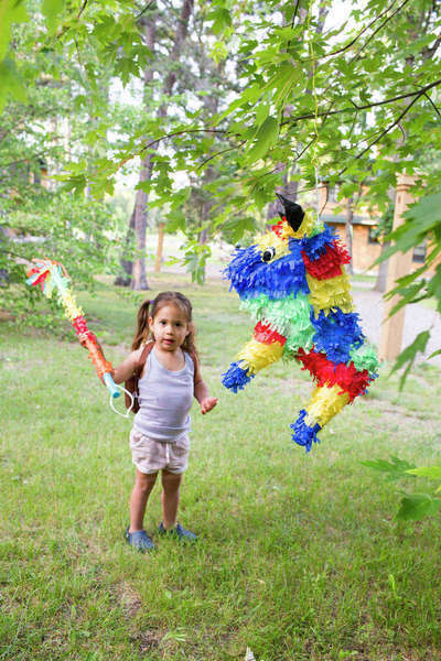 Mixed race girl hitting pinata outdoors - Royalty-free Stock Photo ...
