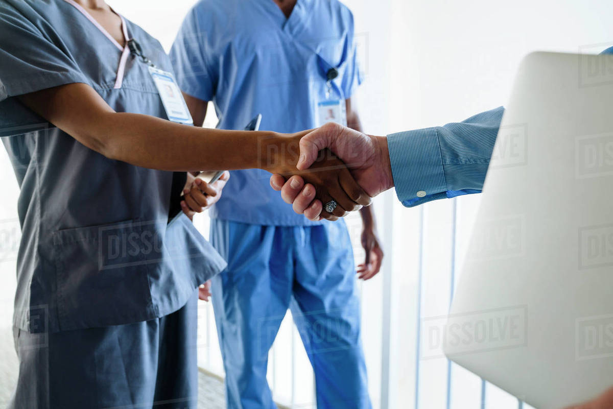 Doctor and nurse shaking hands - Royalty-free Stock Photo | Dissolve