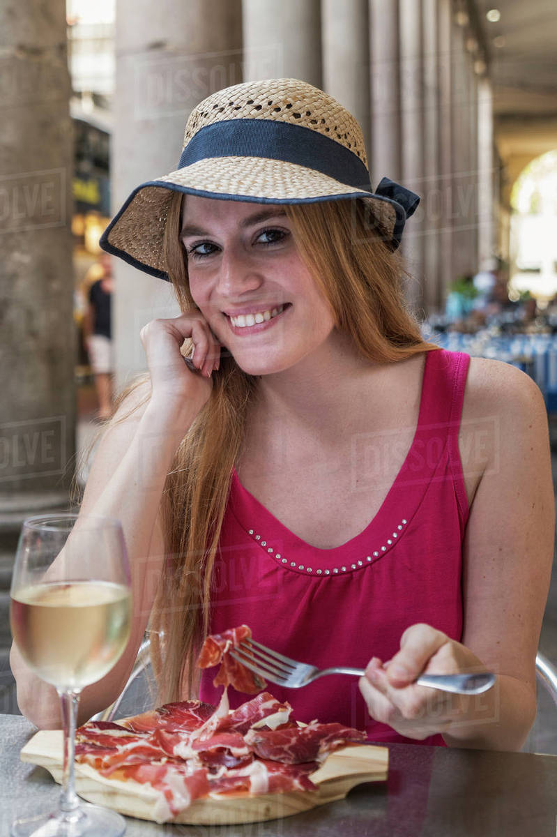 Portrait of smiling Caucasian woman eating meat at restaurant - Stock ...