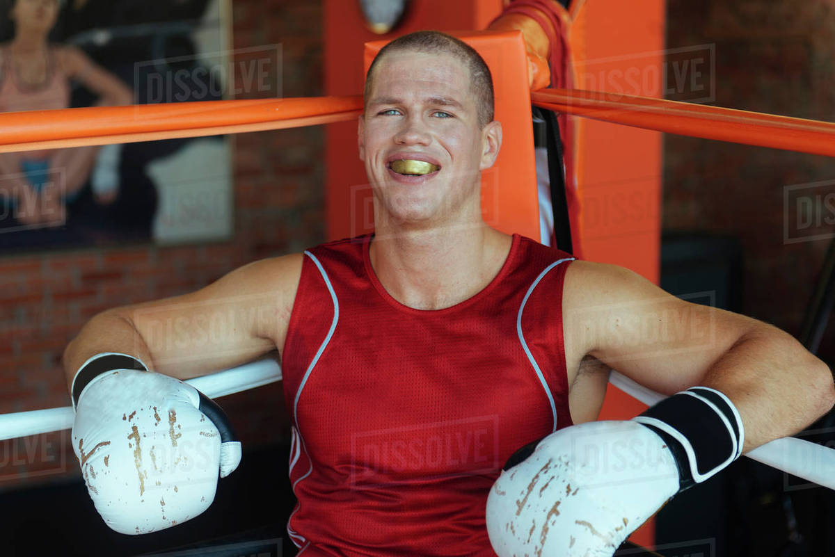 Portrait of Caucasian boxer sitting in corner of boxing ring - Stock ...