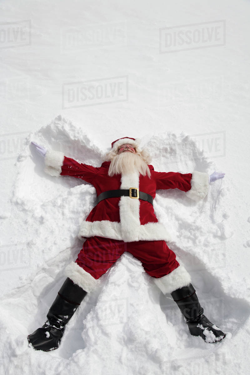 Santa Claus making snow angel outdoors - Royalty-free Stock Photo ...