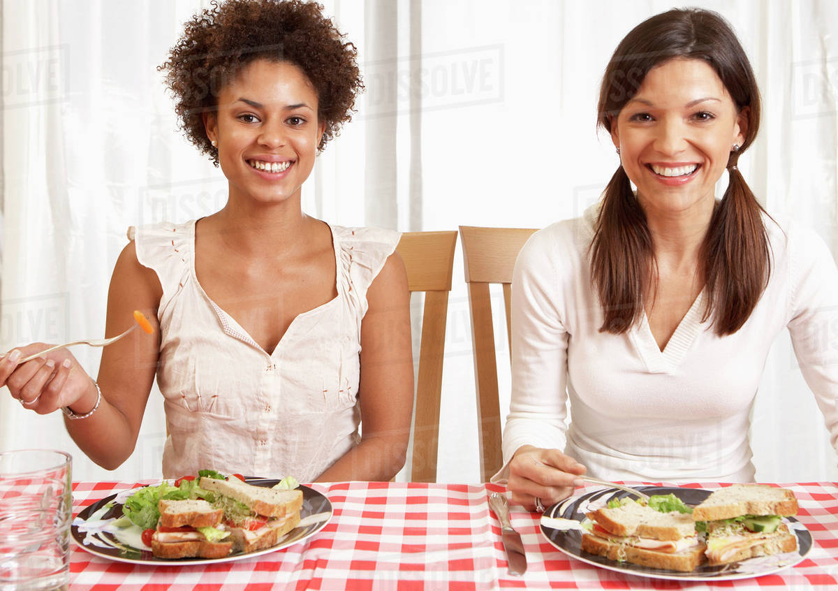Women eating dinner together - Royalty-free Stock Photo | Dissolve