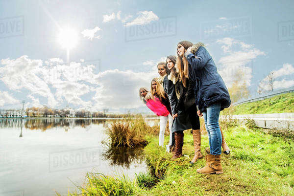 Women overlooking still river - Royalty-free Stock Photo | Dissolve