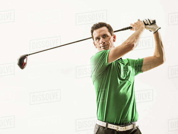 Caucasian man playing golf - Royalty-free Stock Photo | Dissolve