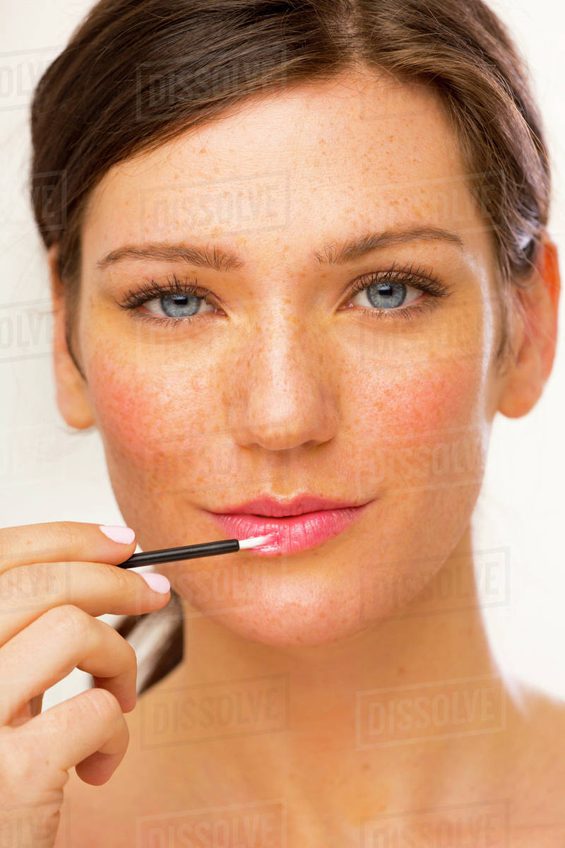 Caucasian woman applying makeup - Royalty-free Stock Photo | Dissolve