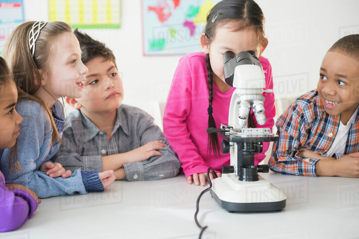 Students using microscope in classroom - Royalty-free Stock Photo ...