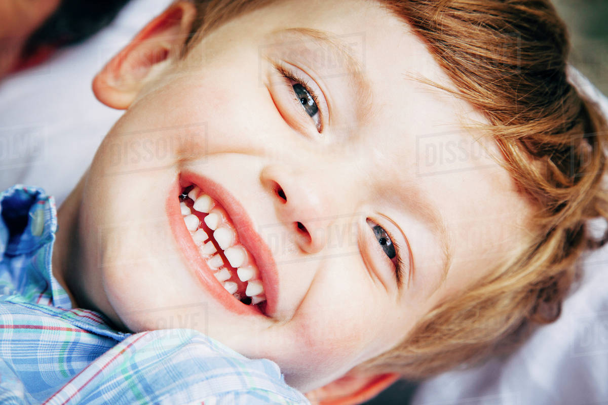 Close up of boy's smiling face - Stock Photo - Dissolve