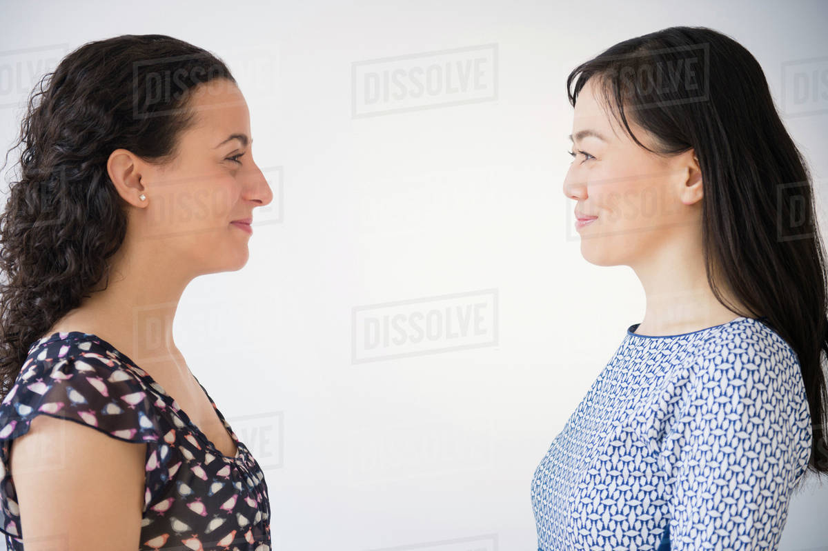 Women smiling at each other - Royalty-free Stock Photo | Dissolve