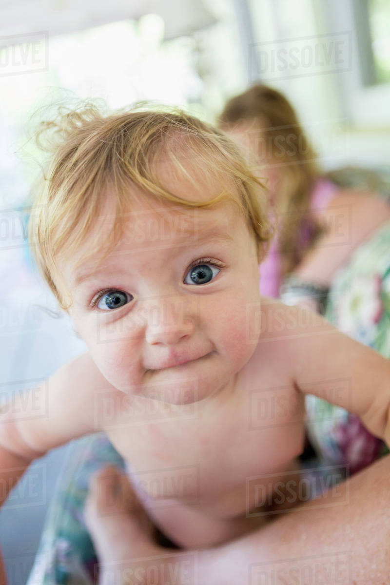 Caucasian baby grimacing - Stock Photo - Dissolve