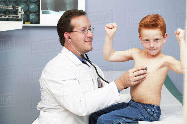 Doctor listening to boy's heartbeat in office - Royalty-free Stock ...