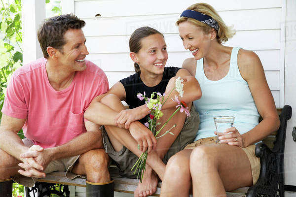 Family relaxing together outdoors - Stock Photo - Dissolve