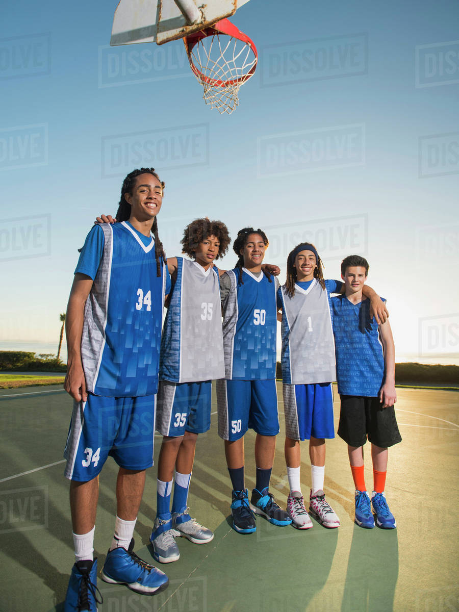 Basketball team posing on court - Royalty-free Stock Photo | Dissolve