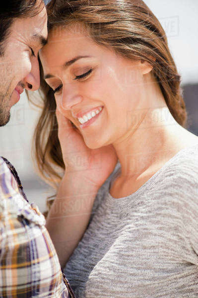 Smiling man caressing face of woman - Royalty-free Stock Photo | Dissolve