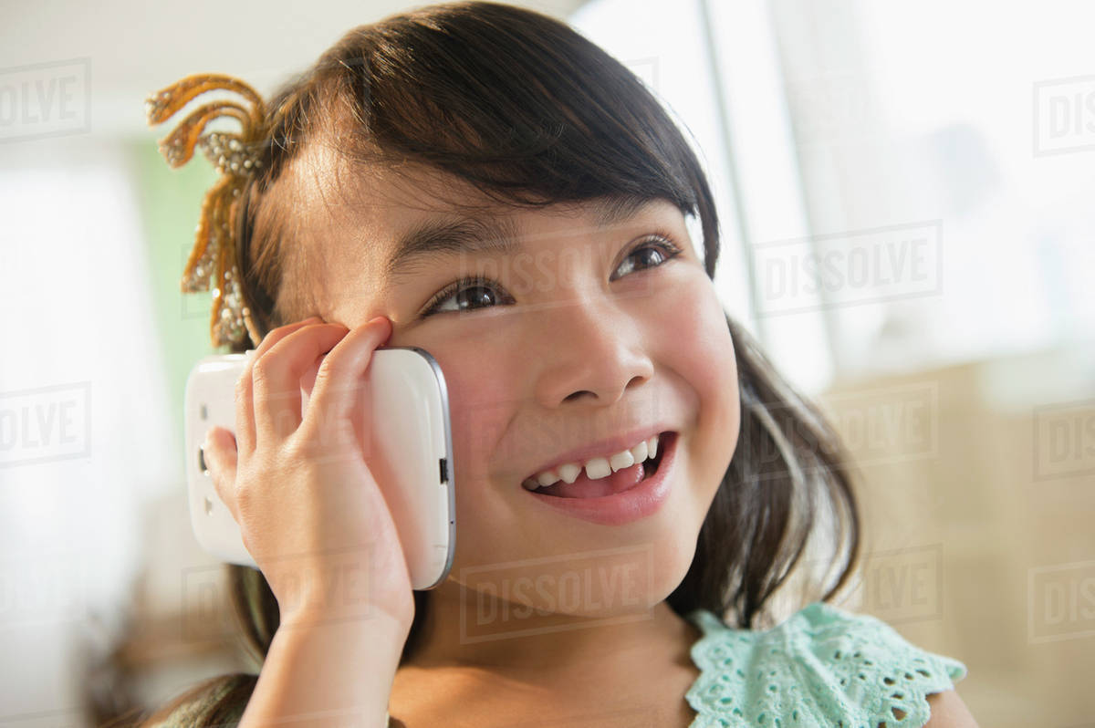 Filipino girl talking on cell phone - Royalty-free Stock Photo | Dissolve