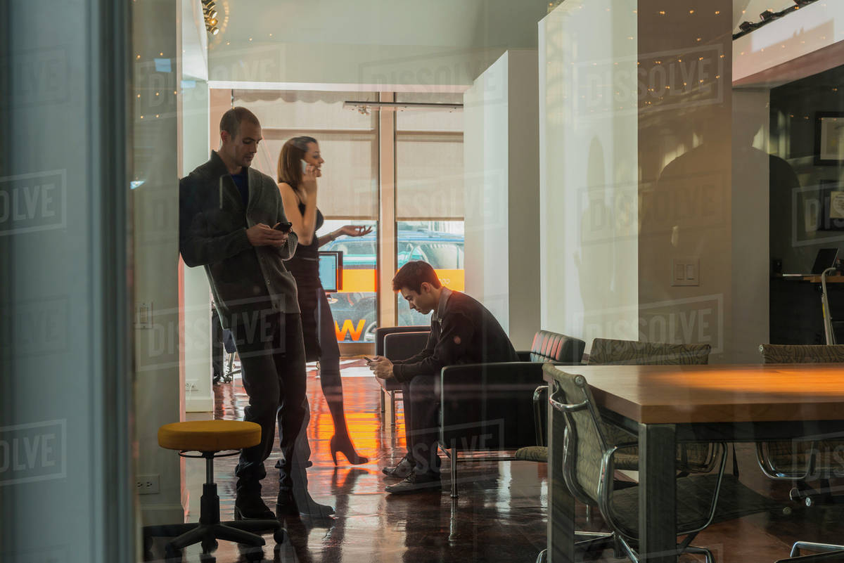 Business people standing in office lobby - Royalty-free Stock Photo ...