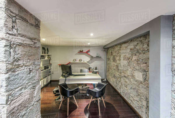 Desk, chairs and stone walls in modern office - Royalty-free Stock ...