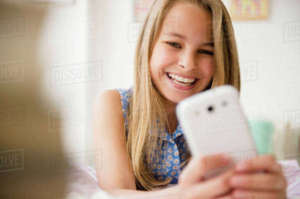 Caucasian girl using cell phone - Royalty-free Stock Photo | Dissolve