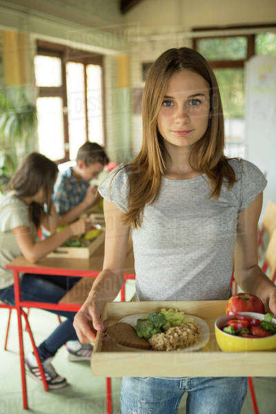 Student carrying lunch tray in school cafeteria - Royalty-free Stock ...