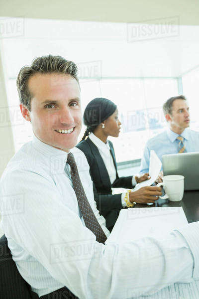 Businessman smiling in meeting - Royalty-free Stock Photo | Dissolve