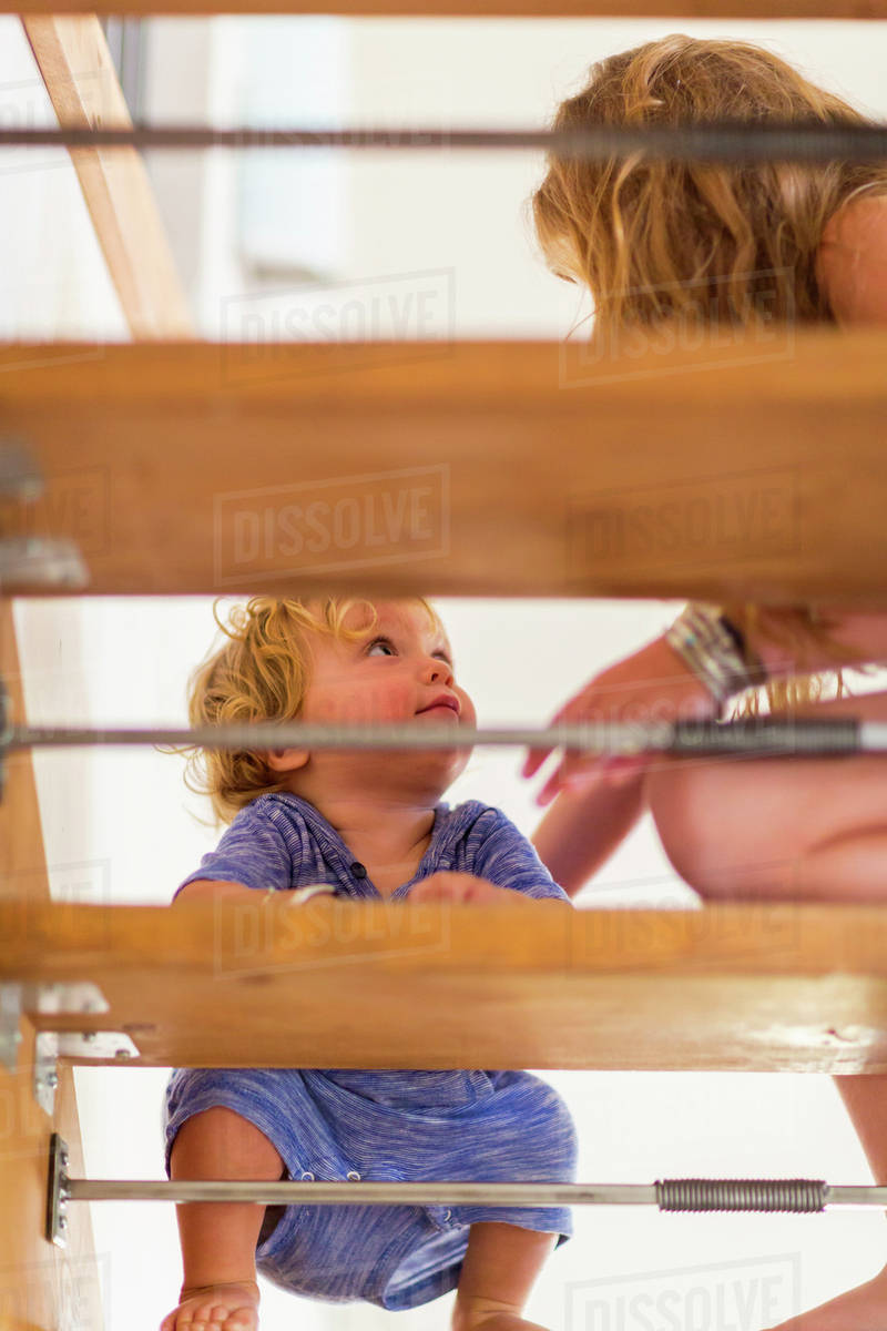 Caucasian girl helping baby brother on staircase - Royalty-free Stock ...