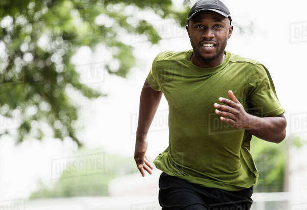 Black man running in park - Royalty-free Stock Photo | Dissolve
