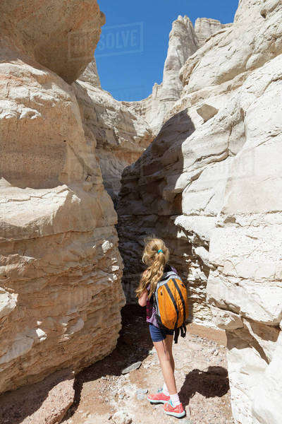 Caucasian girl exploring rock formations - Stock Photo - Dissolve