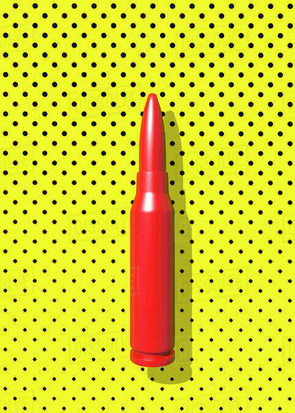 Close up of red bullet casing on polka dot background - Royalty-free ...