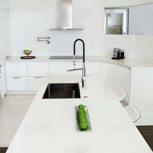 Sink, counter and stove in modern kitchen - Stock Photo - Dissolve