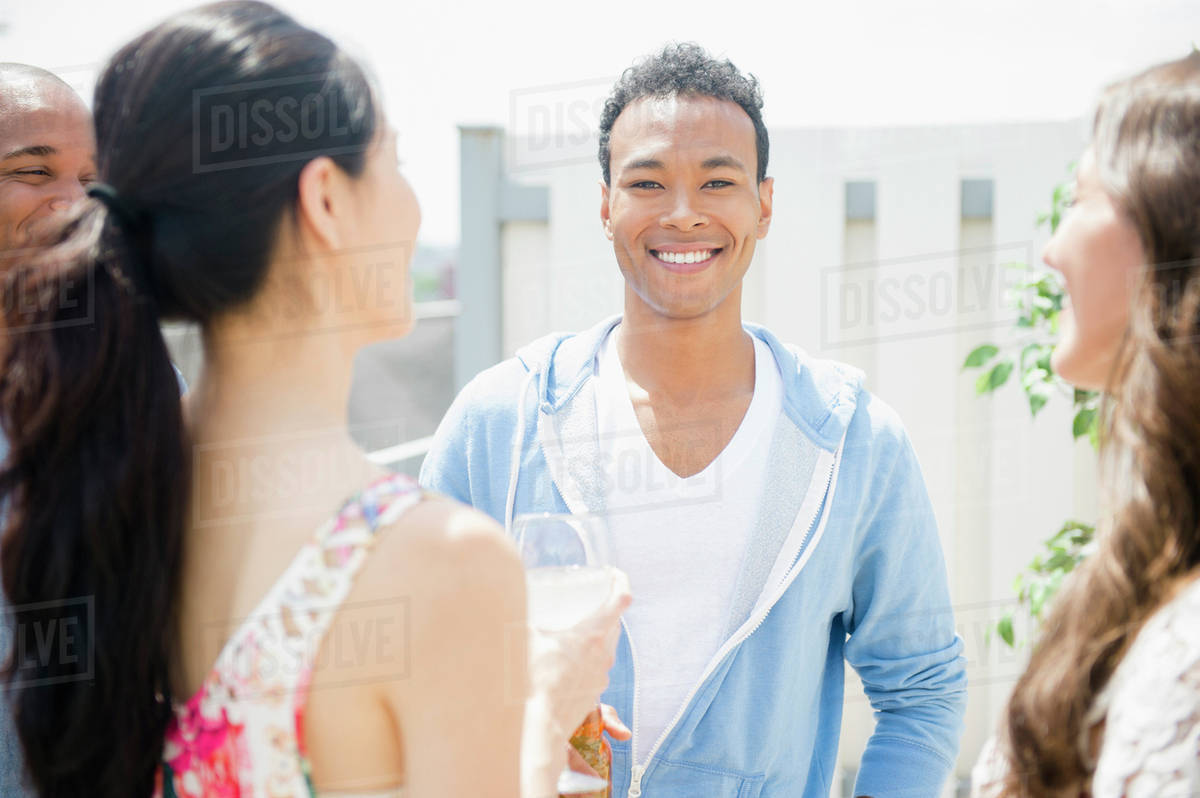 Friends talking at party - Royalty-free Stock Photo | Dissolve