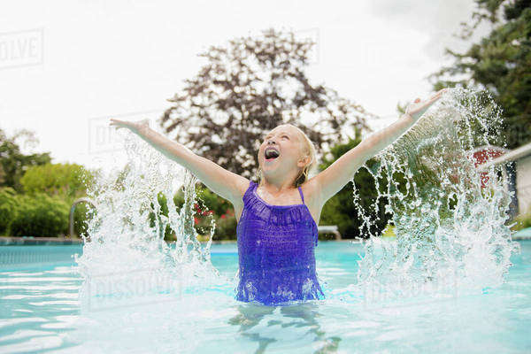 Caucasian girl splashing in swimming pool - Royalty-free Stock Photo ...