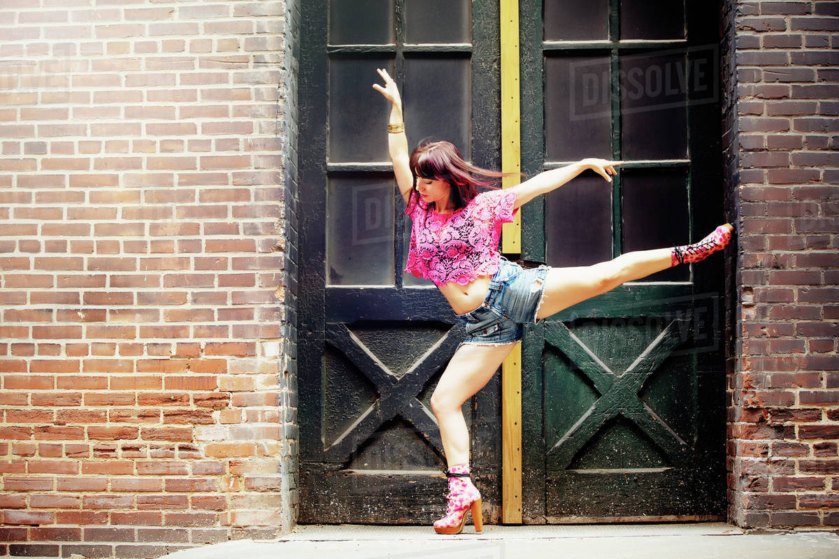 Caucasian woman dancing in doorway - Royalty-free Stock Photo | Dissolve