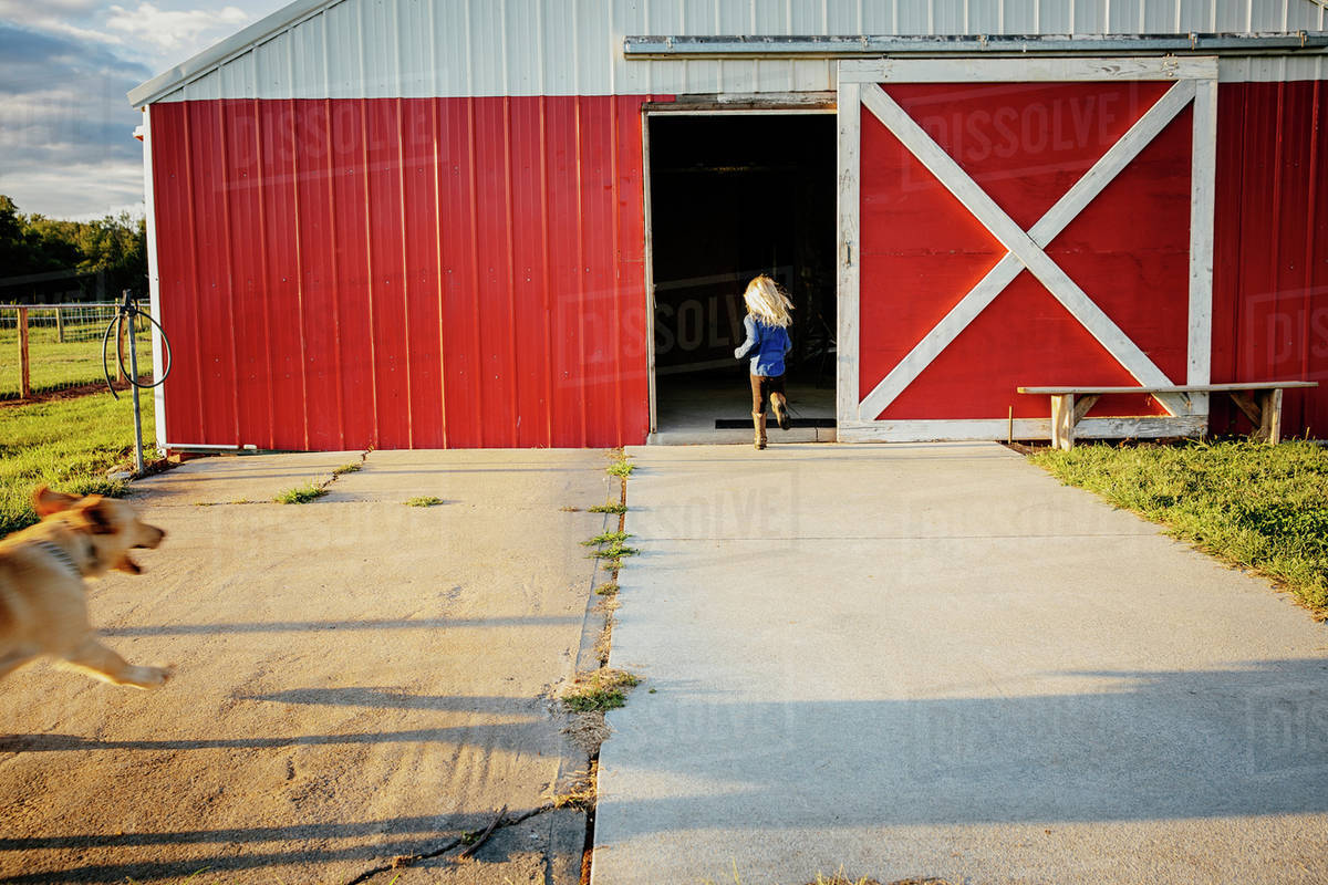 Caucasian girl running to barn on farm - Royalty-free Stock Photo ...