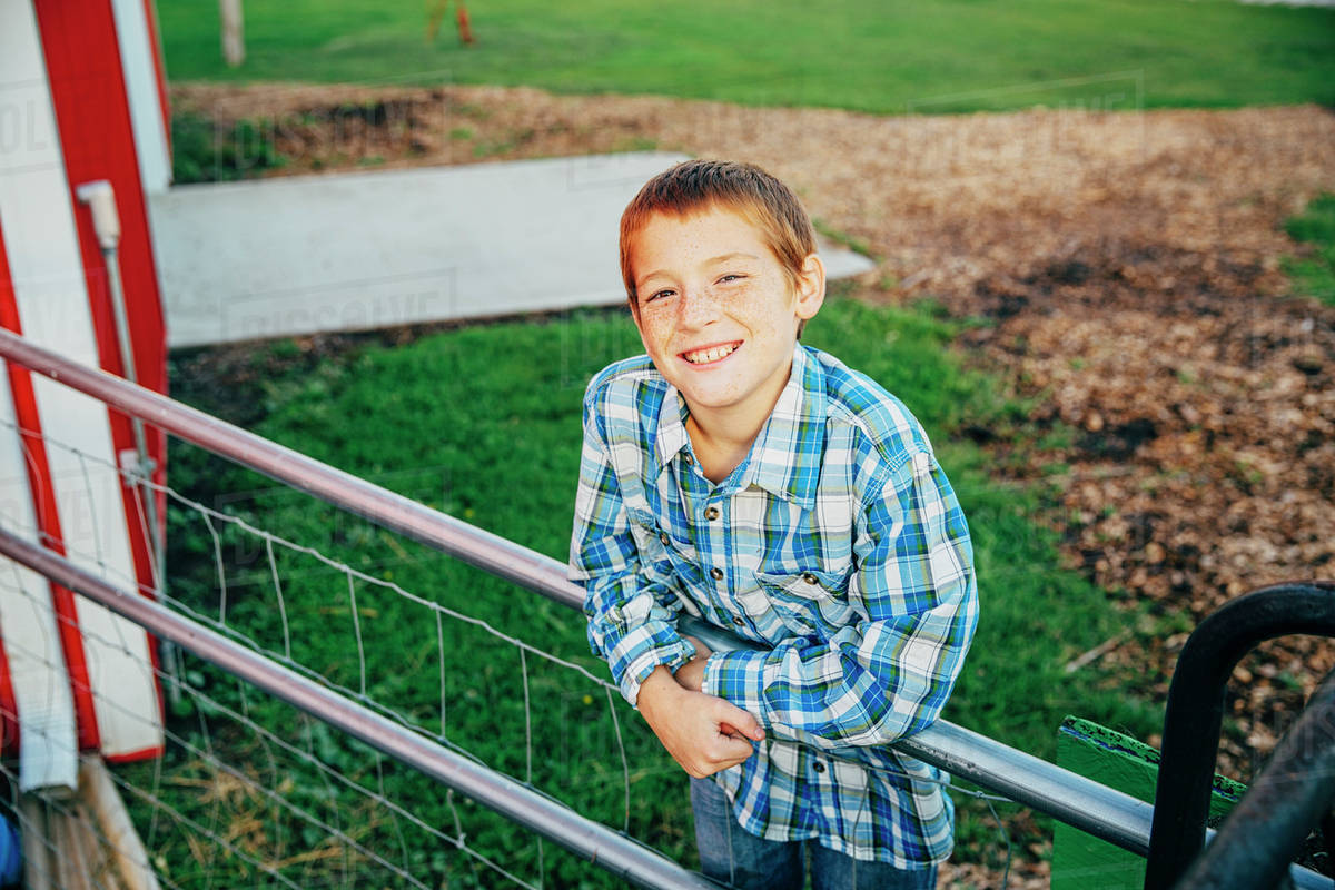 Caucasian boy smiling on farm - Royalty-free Stock Photo | Dissolve