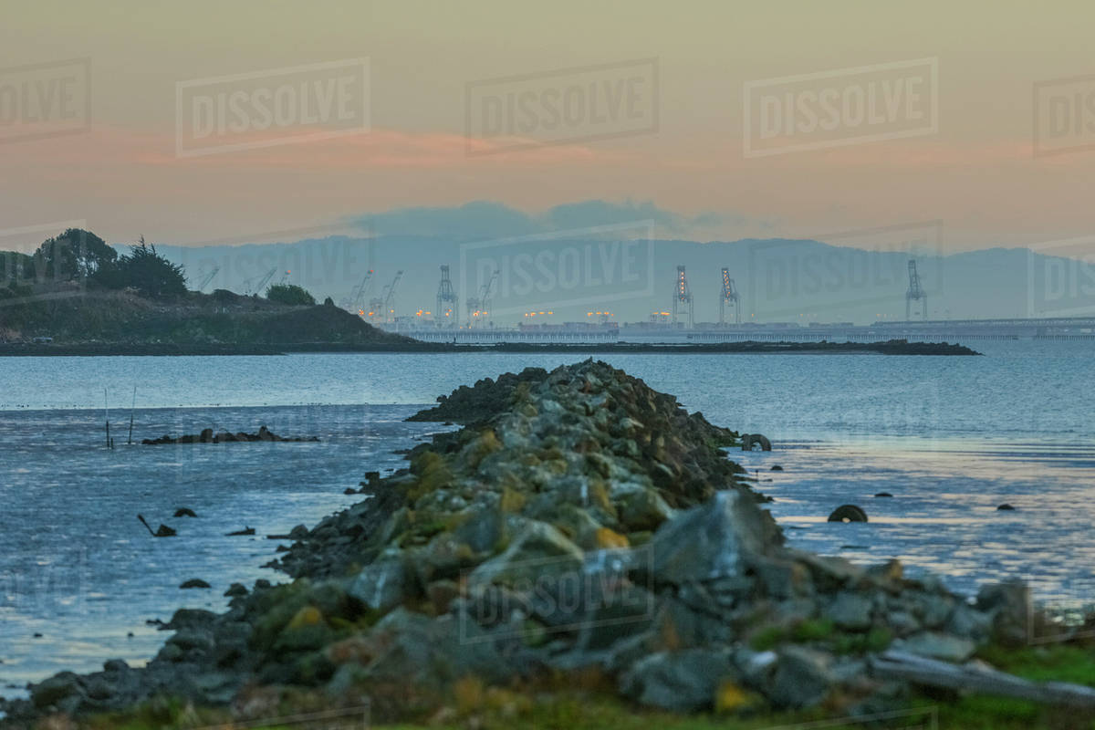 Rocky jetty in ocean bay - Royalty-free Stock Photo | Dissolve