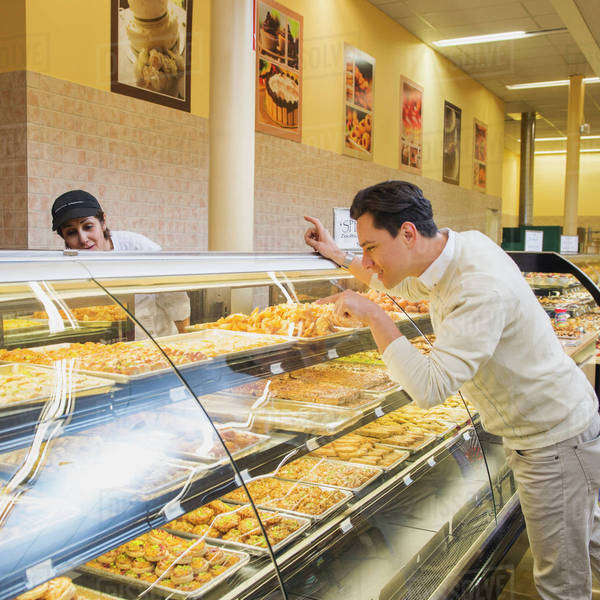 Customer ordering at restaurant counter - Stock Photo - Dissolve