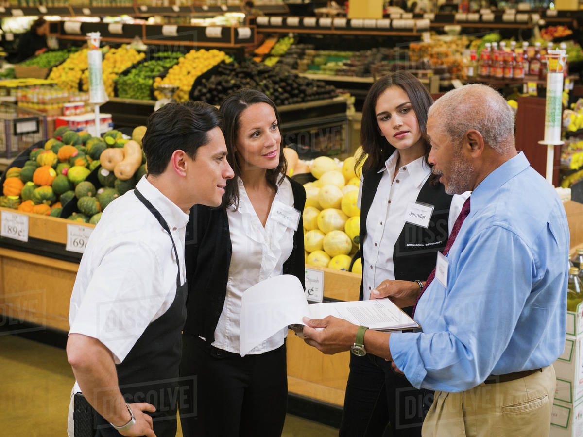 Businessman and workers talking in grocery store - Royalty-free Stock ...
