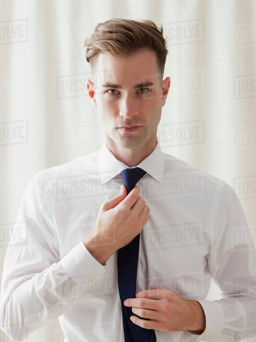 Caucasian businessman adjusting his tie - Royalty-free Stock Photo ...