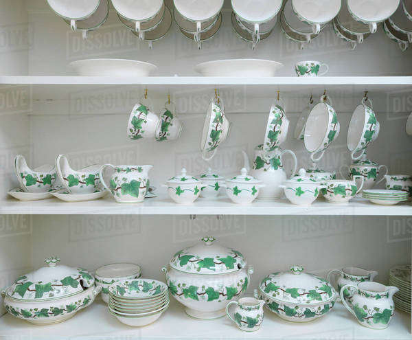 Matching ceramic dinnerware on shelves - Stock Photo - Dissolve