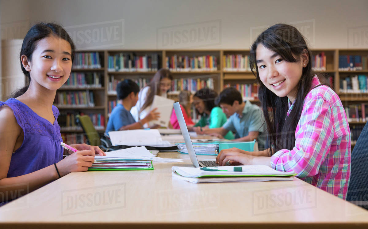Students working together in library - Royalty-free Stock Photo | Dissolve