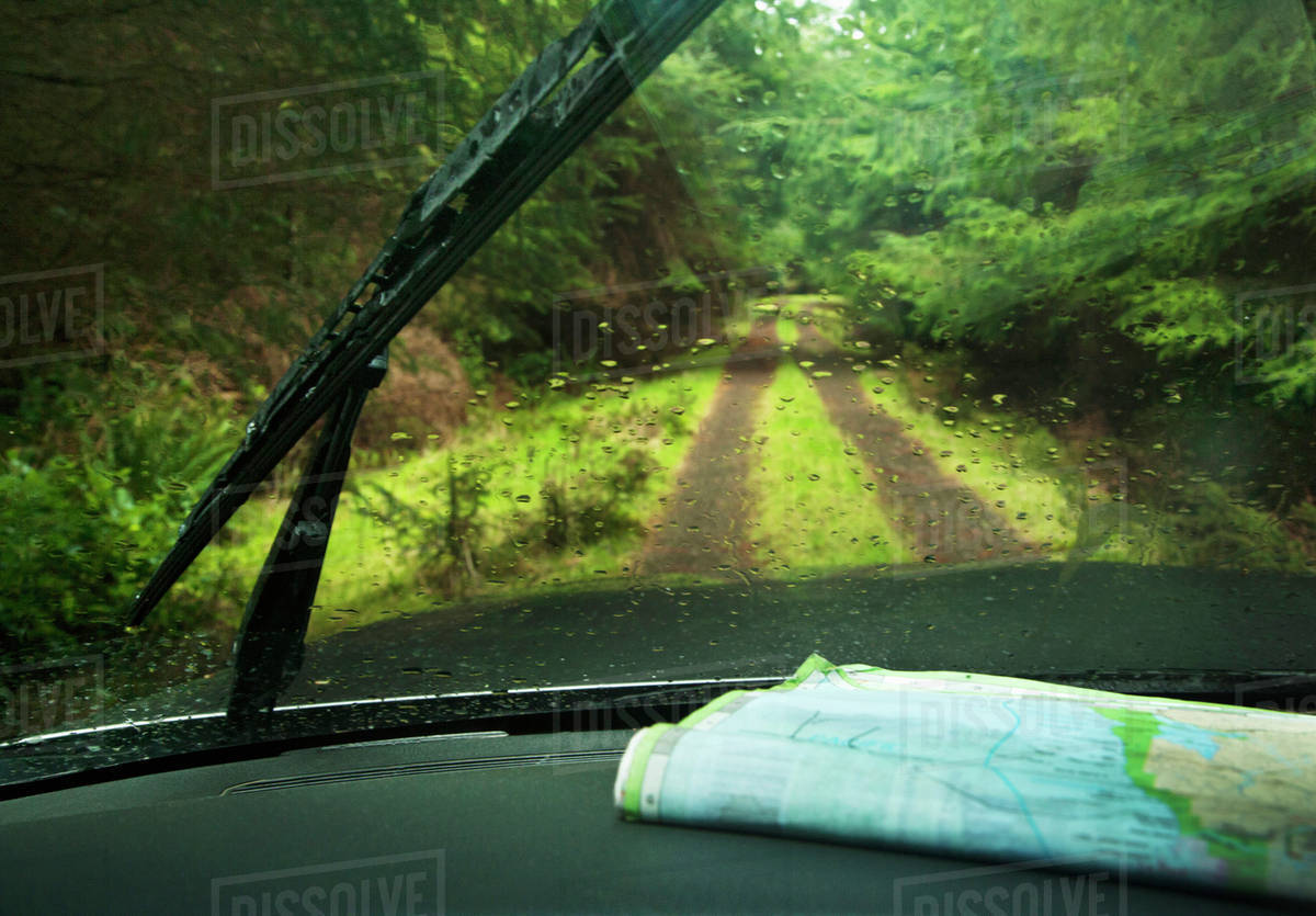 Windshield wipers and map on dashboard of car - Stock Photo - Dissolve