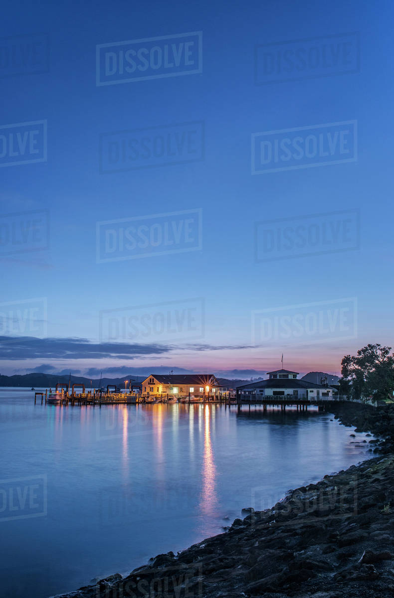 Illuminated buildings on water at dawn - Royalty-free Stock Photo ...