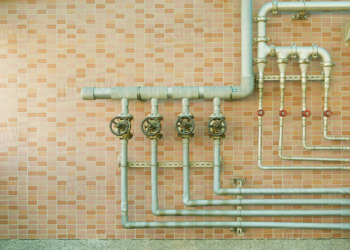 Water pipes on brick wall - Royalty-free Stock Photo | Dissolve